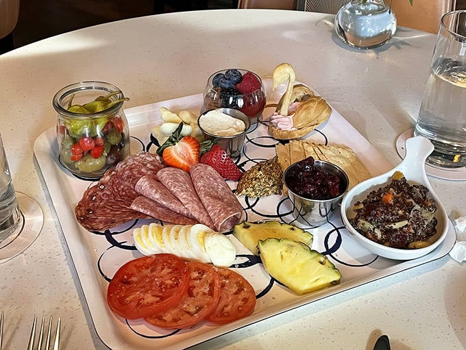 A beautifully arranged charcuterie board showcases cured meats, cheeses, and seasonal fruits &ndash; perfect for sharing while plane-watching.