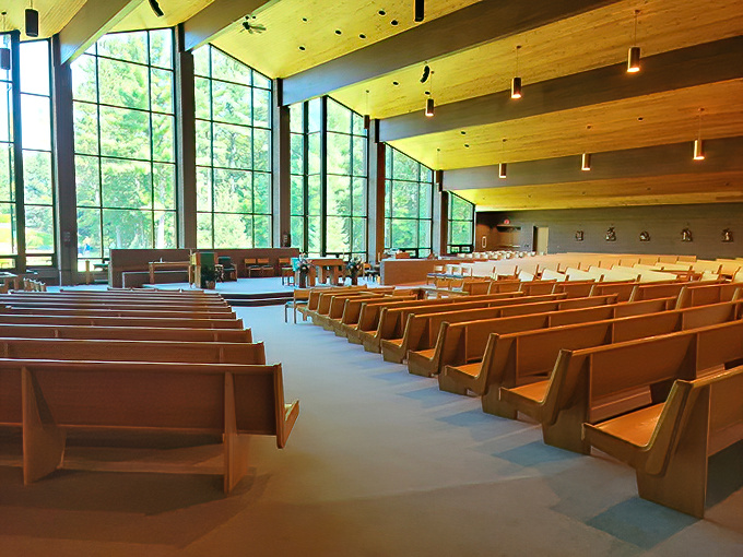 Natural light floods the sanctuary through dramatic windows, creating a space where architecture and nature work in perfect harmony.