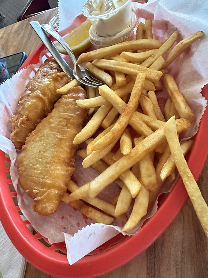 Fish and chips that would make British pubs jealous, golden-battered Atlantic cod lounging on a bed of crispy fries like royalty.