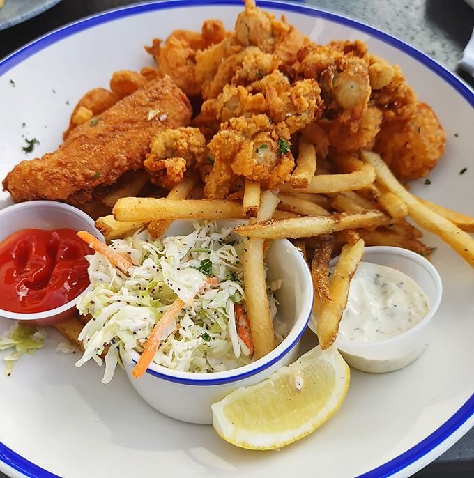 Fried seafood nirvana! This platter doesn't just feed you &ndash; it tells stories of Maine's fishing heritage with every golden, crispy bite.