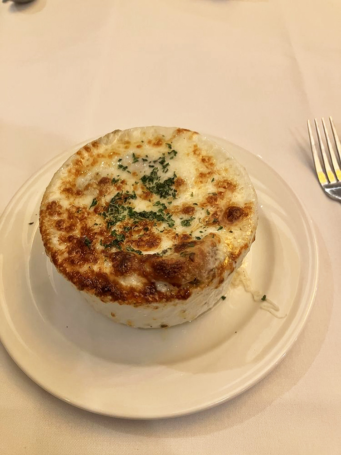 The French onion soup arrives like a warm hug in a crock &ndash; savory broth topped with a melty cheese cap that stretches dramatically with each spoonful.
