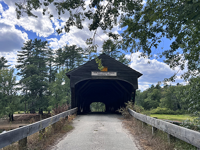 The approach to Hemlock Bridge reveals its classic covered design, standing sentinel over the Old Course Saco River since before the Civil War.