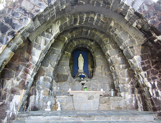 The Grotto of Our Lady of Lourdes, with its stone archway and sacred statuary, offers a piece of European spiritual tradition in coastal Maine.