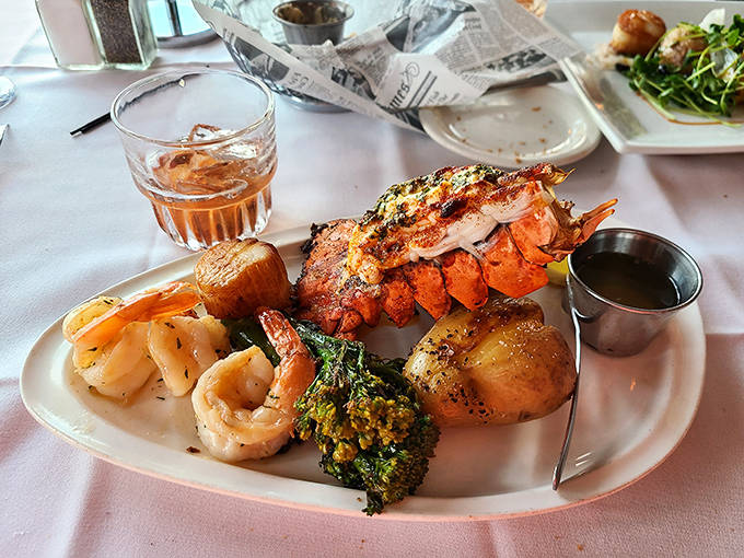 A plate that makes decisions easy – perfectly cooked lobster tail, succulent shrimp, and sweet scallops with seasonal vegetables.