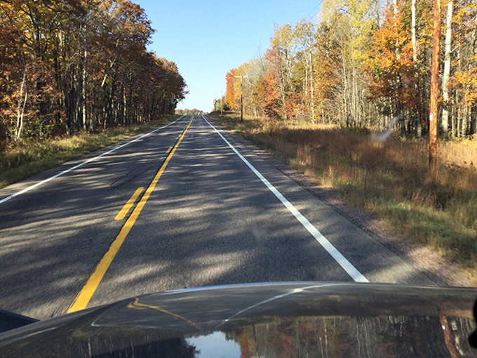 Rural roads stretch toward the horizon like ribbons unwrapping Wisconsin's countryside gifts &ndash; each curve promising new discoveries.