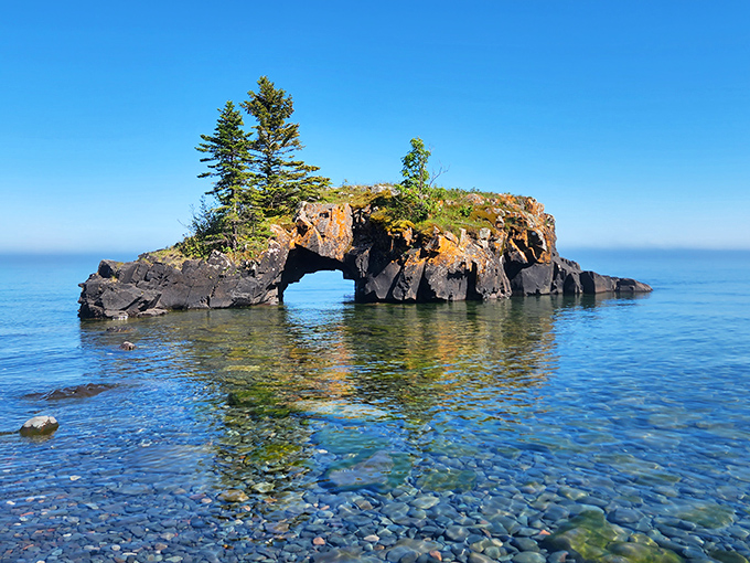 Hollow Rock stands like nature's own stone bridge, somehow balancing a mini-forest on top &ndash; engineering that would make architects jealous.