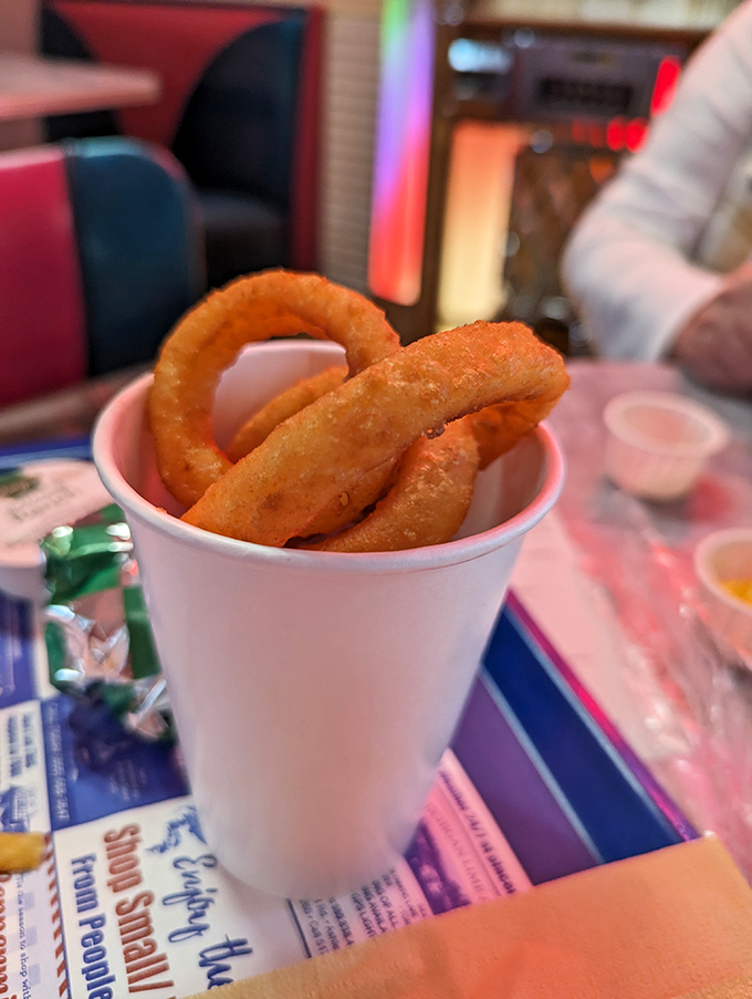 Golden halos of crispy perfection that make you question why anyone would ever choose fries when these crunchy wonders exist.