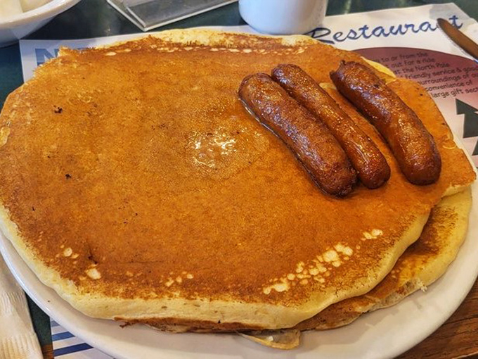 The breakfast trifecta: a pancake large enough to use as a toboggan, paired with sausages that mean serious business.