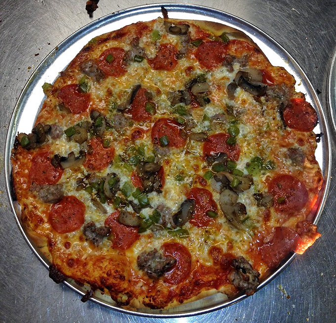 Pepperoni Combo Pizza: Green peppers add a sweet crunch to classic pepperoni, mushrooms bring earthiness, and that thin crust ties everything together in perfect harmony.
