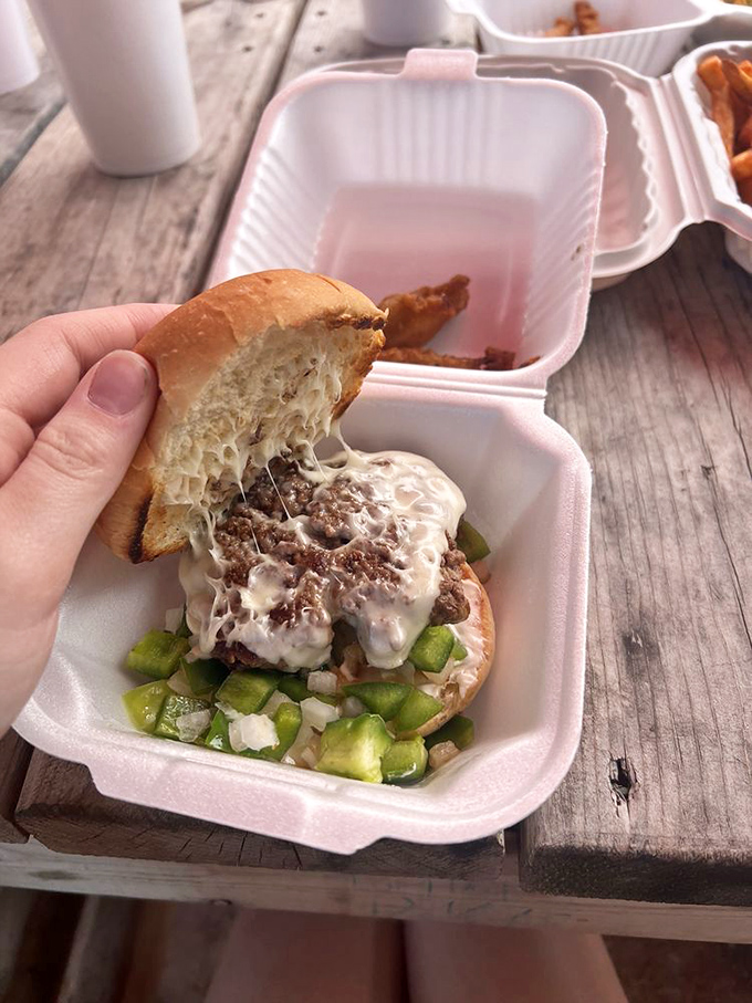 This beautiful mess requires strategic eating and multiple napkins, tender beef, green peppers, and cheese creating a handheld symphony of flavors.