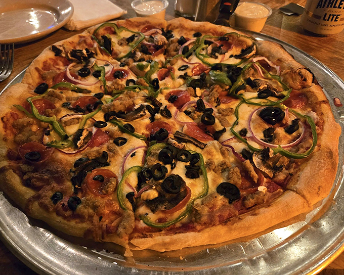 The Works pizza lives up to its name &ndash; loaded with toppings from edge to edge, it's a flavor explosion that requires both hands and possibly a nap afterward.