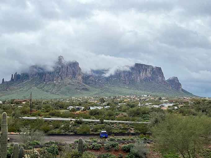 The Superstition Mountains brood dramatically in the distance, living up to their mysterious name with every cloud-wrapped peak.