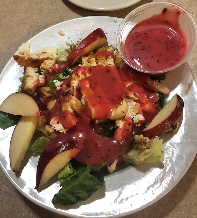 Fresh salads with grilled chicken and strawberry vinaigrette offer a lighter option that's actually satisfying, not just virtuous and sad.