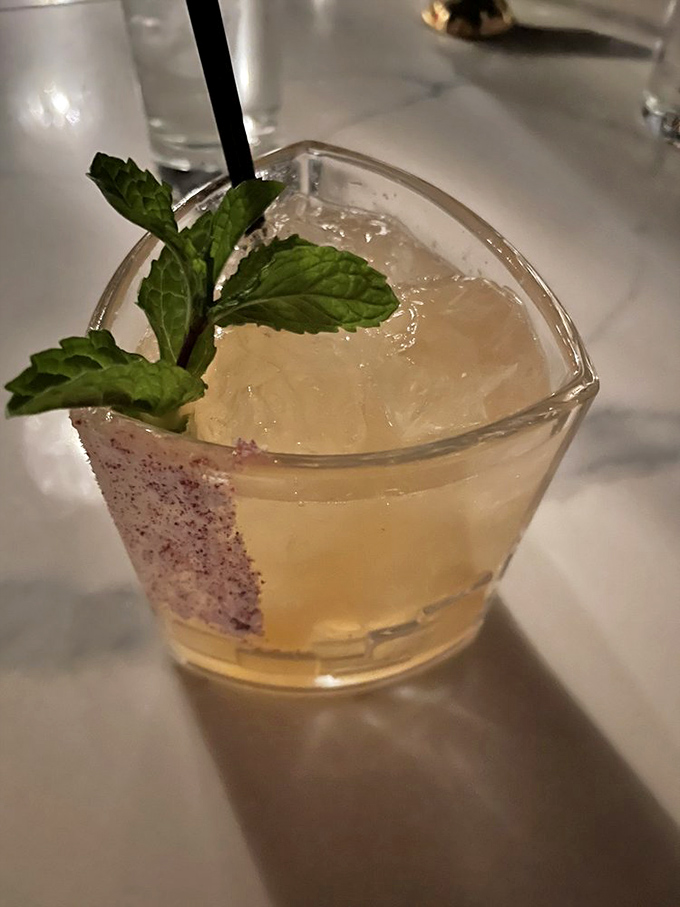 Mixology meets artistry in this mint-garnished concoction, where the glass is as carefully chosen as the spirits within it.