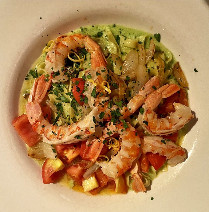 Plump shrimp nestled among fettuccine ribbons in a vibrant sauce &ndash; like finding treasure in a pasta sea.