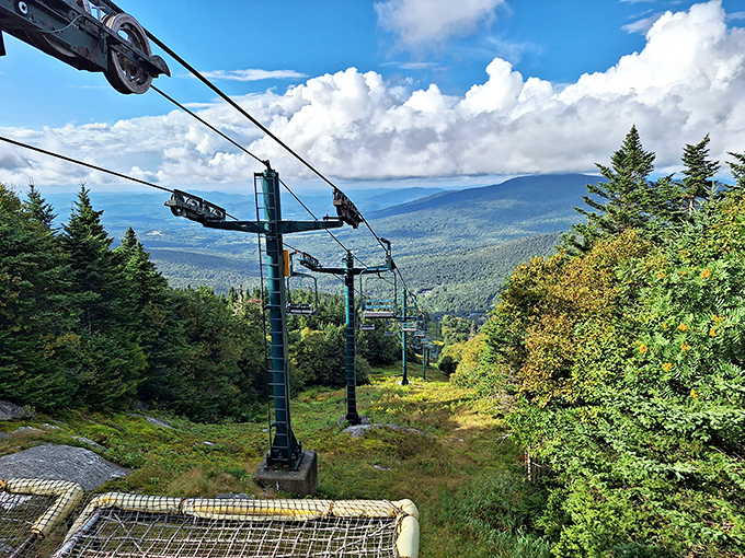 Empty chairlifts swing gently in summer breezes, waiting patiently for snow while offering stunning valley panoramas.