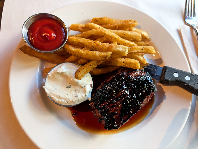 Steak frites arrives like a French classic should, perfectly charred meat meeting crispy golden fries in a marriage arranged by culinary heaven itself.