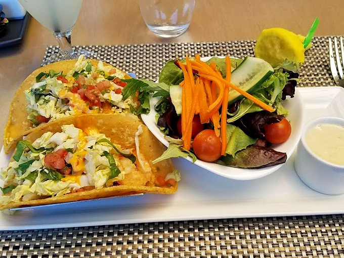 Crispy fish tacos share the spotlight with a garden-fresh salad &ndash; proof that indulgence and virtue can peacefully coexist on one plate.