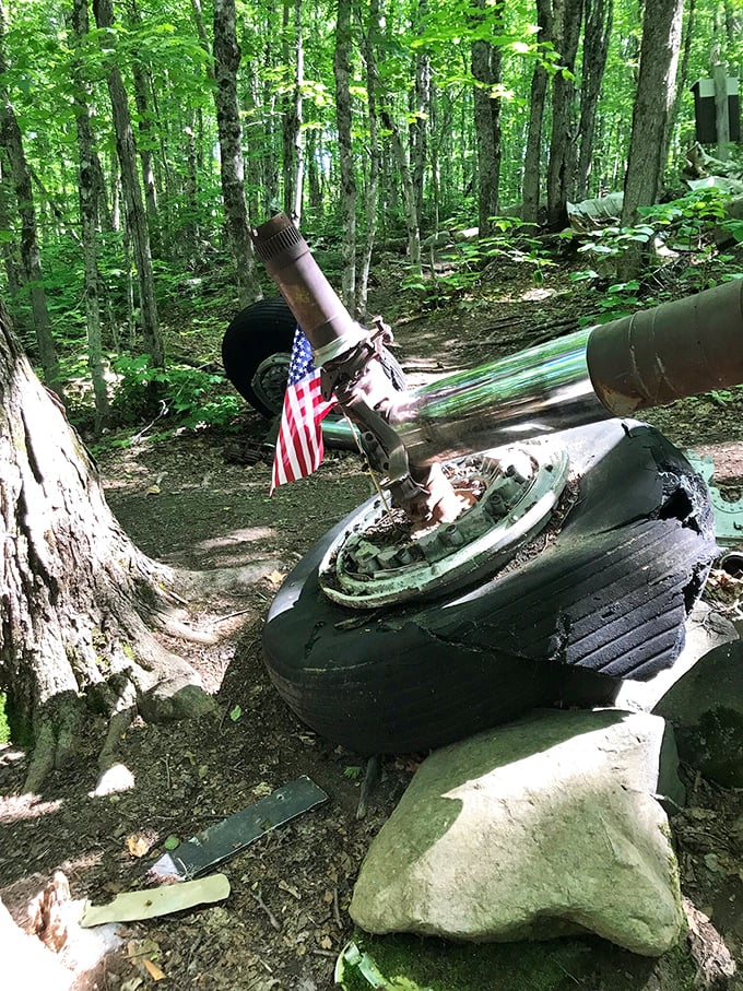A massive landing gear assembly rests against the forest floor, its size hinting at the enormous aircraft that once carried it.
