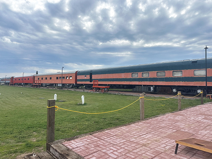 A lineup of vintage train cars rests under moody skies, each with stories to tell and adventures to offer.