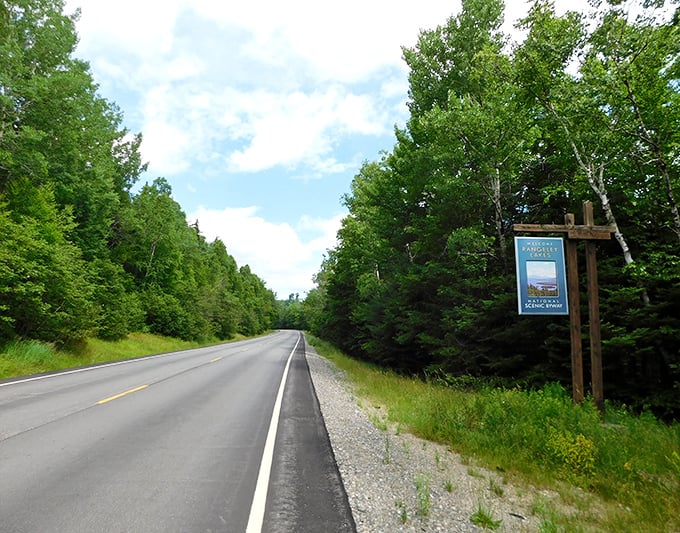 Welcome to paradise: the Rangeley Lakes Scenic Byway sign stands sentinel at the gateway to Maine's natural wonderland.