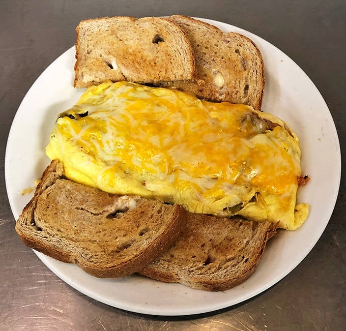 Breakfast simplicity at its finest &ndash; a perfectly executed omelet nestled between slices of toast. No fancy tricks, just honest-to-goodness morning satisfaction.