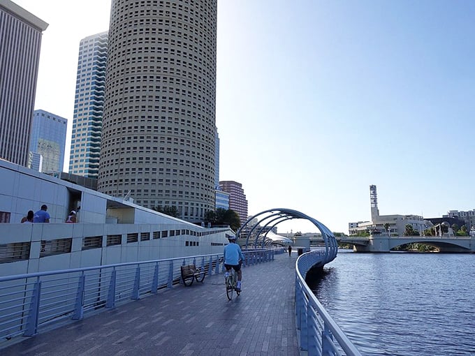 Cyclists enjoy the smooth, dedicated pathways of the Riverwalk, where exercise meets sightseeing under Tampa's famously blue skies.