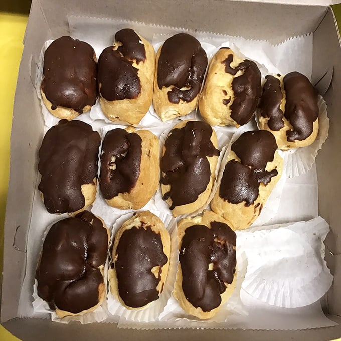 Chocolate-topped eclairs that would make a French pastry chef weep with joy – the perfect balance of crisp choux, creamy filling, and glossy topping.