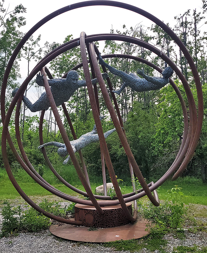 Frozen in eternal free fall, these metallic figures tumble through space in an artistic paradox that captures motion in stillness.