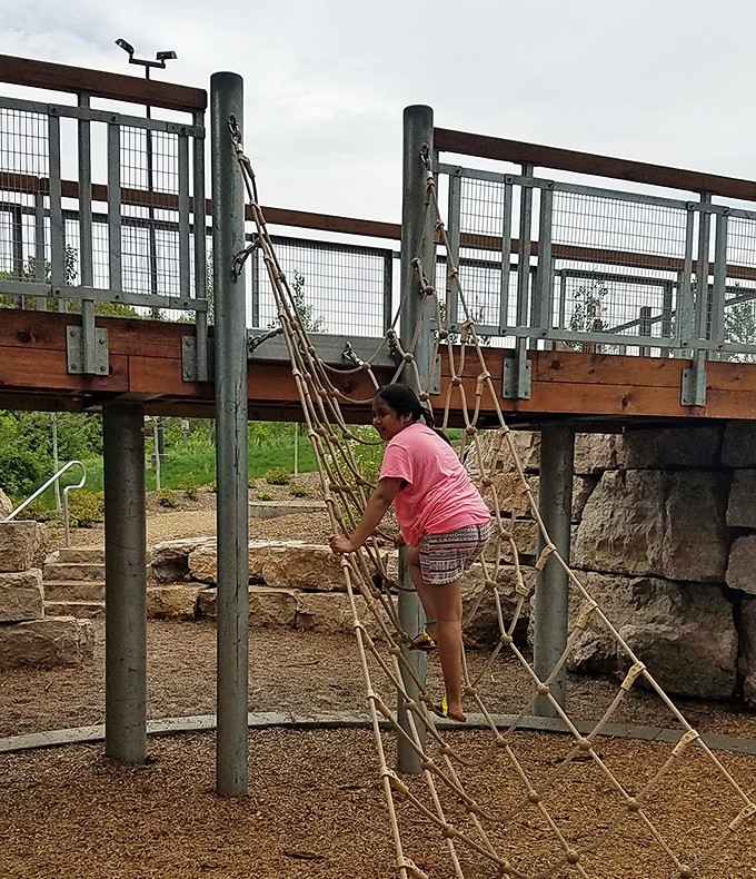 Scaling the rope net with determination that would impress mountain climbers &ndash; childhood adventures at their finest.