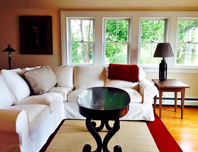 The living room blends nautical heritage with contemporary comfort, creating a space where conversations flow as easily as the nearby waves of Lake Superior.