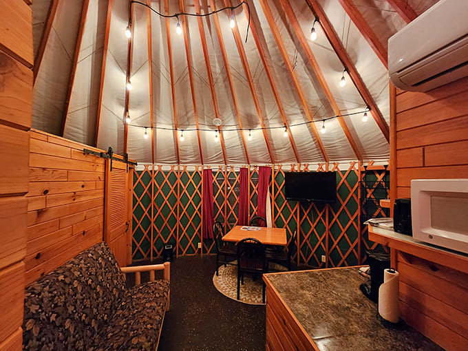 Inside a yurt, wooden warmth and cozy furnishings create a space that's somehow both rustic and refined, like camping went to finishing school.