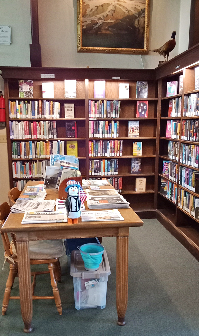 Light streams through shelves onto comfortable reading chairs, creating the perfect spot to lose yourself in a Maine maritime adventure.