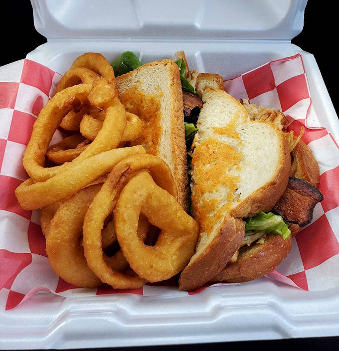 A towering creation nestled beside golden onion rings &ndash; proof that Betty's savory game is as strong as its sweet.