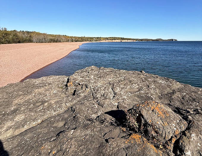 The perfect crescent of pink embraces Lake Superior's blue expanse, a color contrast that photographers and painters can't resist capturing.