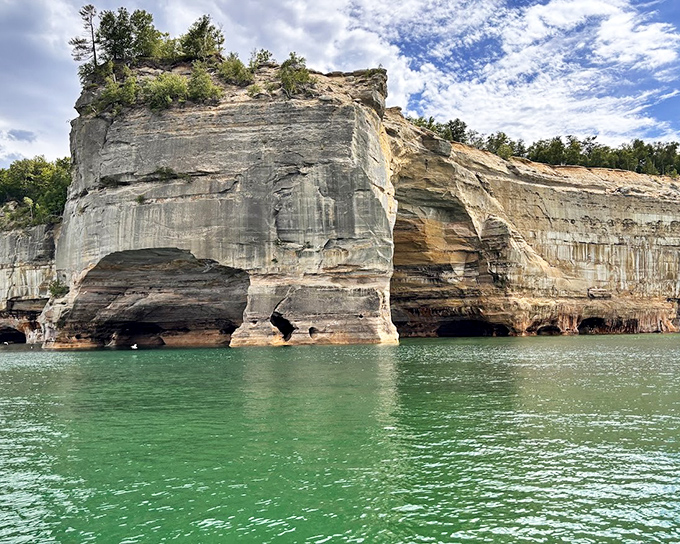 Ancient waves carved this magnificent sea cave with the patience only water possesses, creating a natural cathedral where Lake Superior plays both architect and artist.