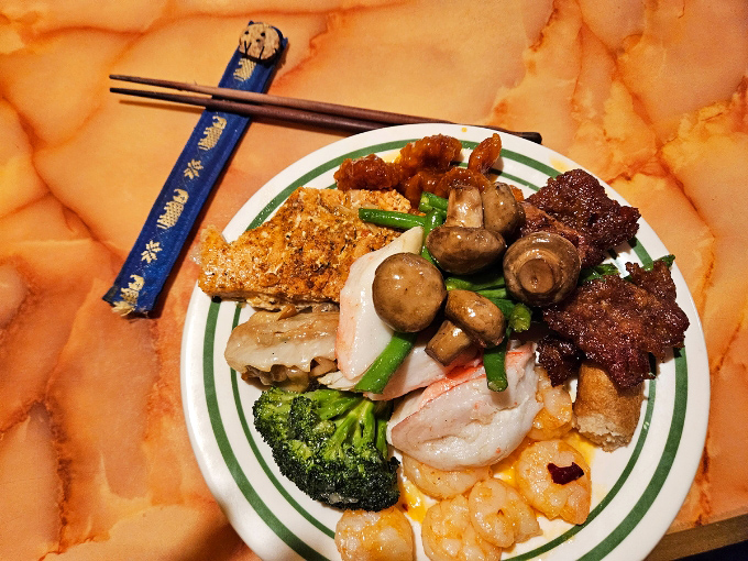 A strategic sampler's plate showcases the buffet's diversity &ndash; from tender beef to mushrooms and broccoli, all coexisting in harmony.