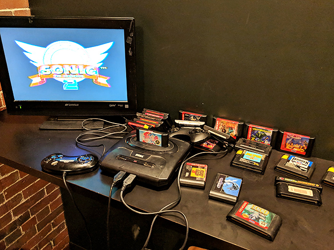 A Sega Genesis setup surrounded by cartridges offers a portal to the 16-bit era, when Sonic was king and gameplay trumped graphics.