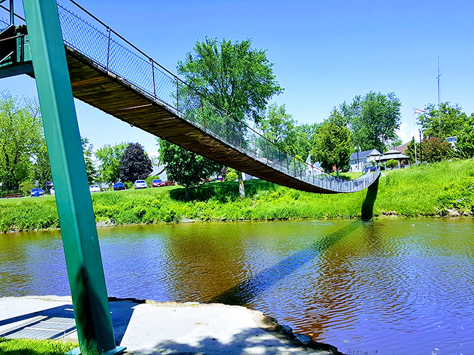 Looking up from below reveals the simple yet effective engineering that's kept this bridge swinging safely for over a century.