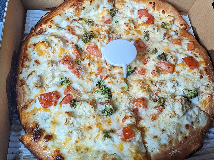 Their white pizza showcases a velvety canvas of creamy sauce and cheese, adorned with fresh vegetables for a lighter option.