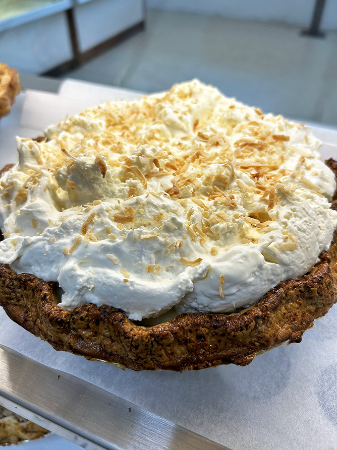 Coconut cream pie crowned with toasted coconut flakes and whipped cream &ndash; the kind of dessert that makes you close your eyes with each bite.