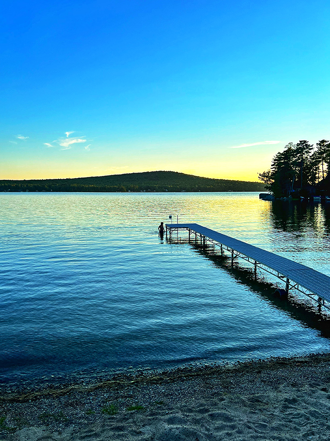 Beech Hill Pond's remarkable clarity showcases underwater features, with the shoreline home perfectly positioned for sunrise swims. 