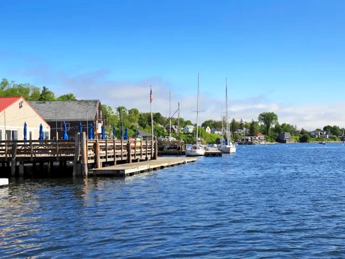 Castine's waterfront reveals its maritime heritage, with docks extending into the calm harbor waters.