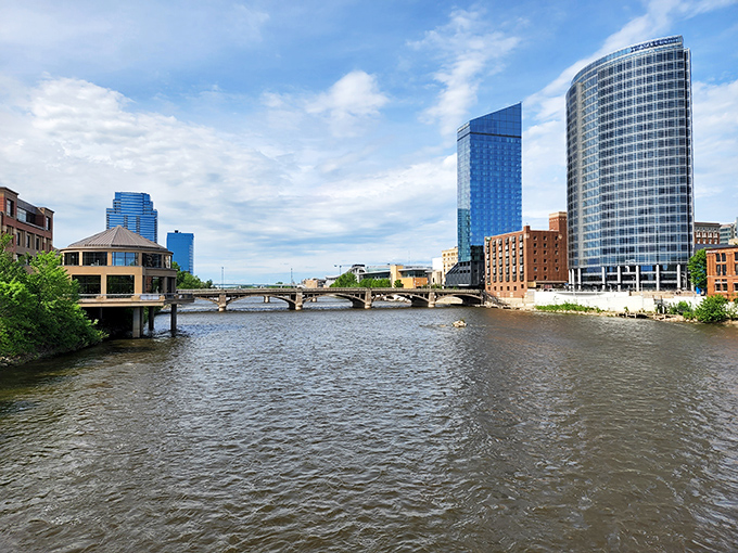 Grand Rapids' modern skyline reflects in the Grand River, showing the perfect blend of nature and urban design.