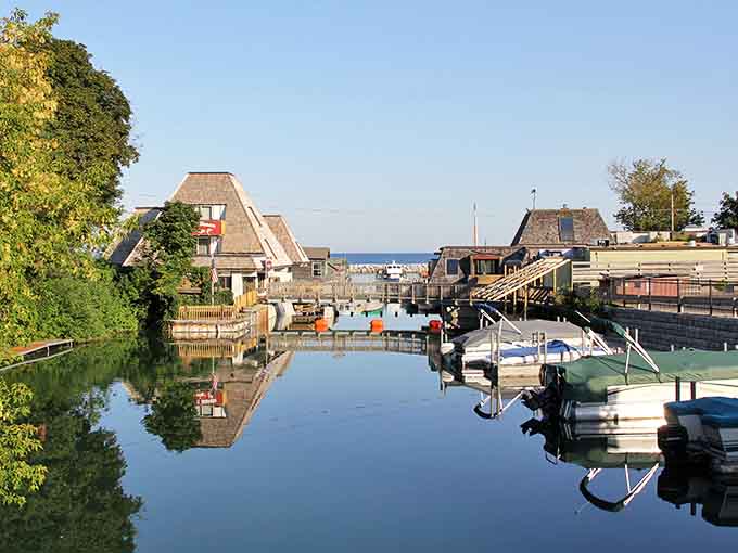 Fishtown's weathered shanties reflect perfectly in the calm harbor water, creating a scene that photographers dream about capturing.