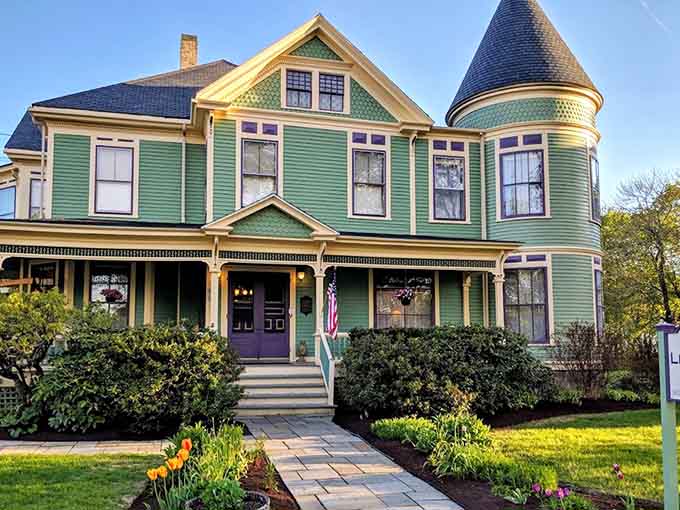 The Victorian charm of LimeRock Inn welcomes lighthouse enthusiasts with its distinctive green exterior and purple accents in Rockland.