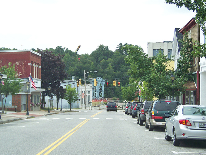 Lisbon's quaint main street features classic New England architecture with a mix of brick buildings and tree-lined sidewalks.