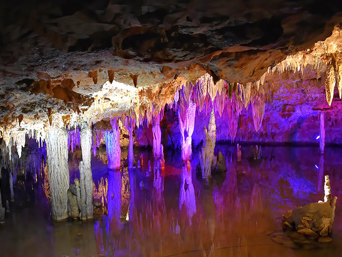 Colorful lighting transforms ancient cave formations into a magical underground wonderland at Meramec Caverns.