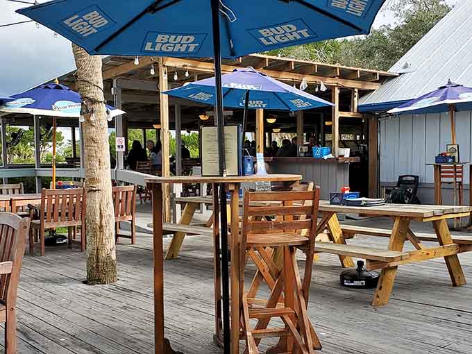 Wooden decks and blue umbrellas create the ideal waterfront dining spot for fresh seafood and cold drinks.