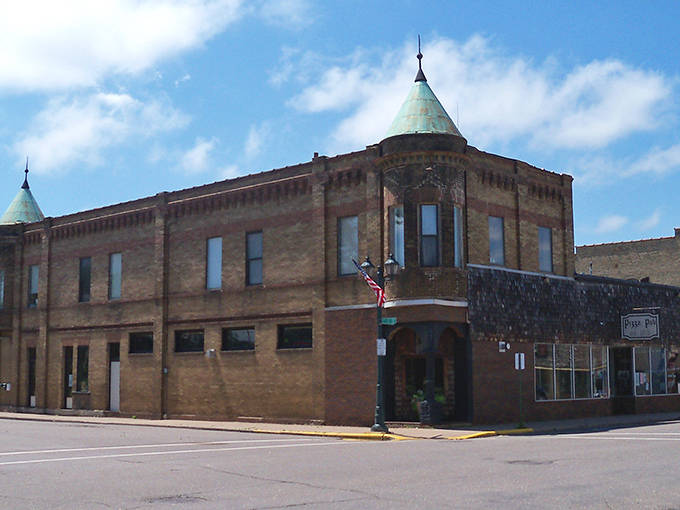Pizza Pub's historic building with distinctive turrets adds architectural charm to Pine City's downtown landscape.